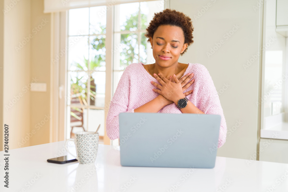Young african american woman working using computer laptop smiling with ...