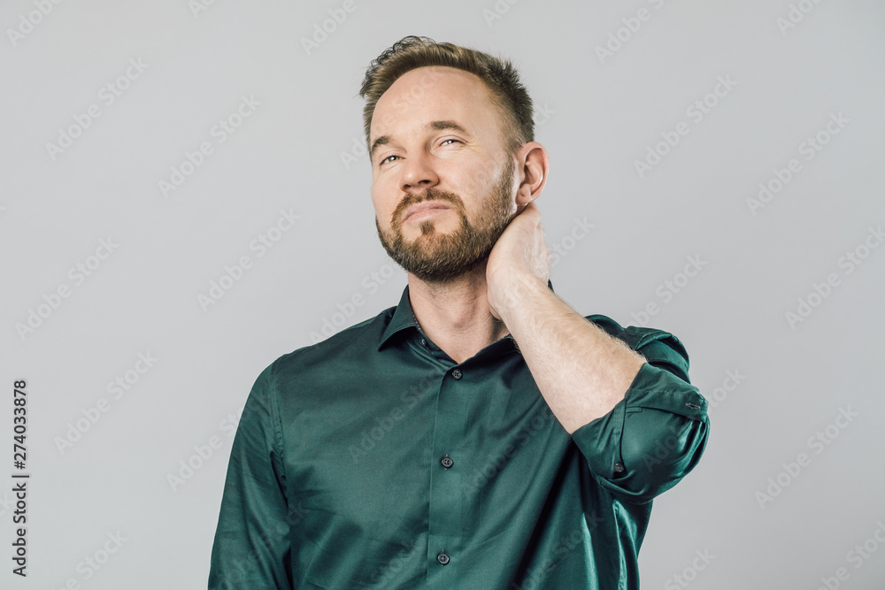 Frustrated man holding hand on his neck, having pain on the back Stock ...