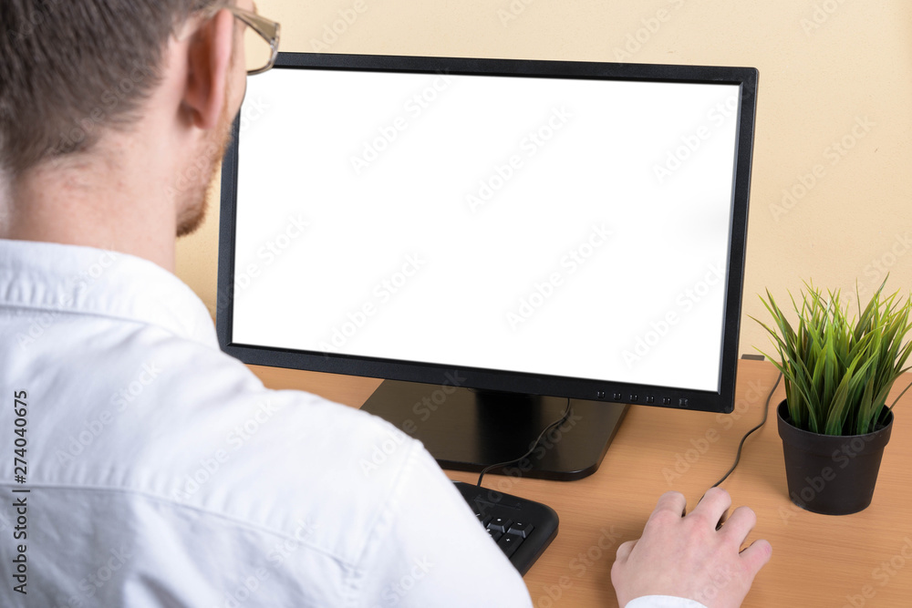 Businessman looking at computer screen using a desktop computer with a ...