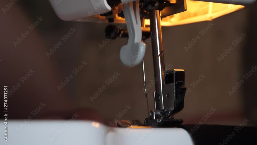 Sewing Machine Needle in Motion. Close-up of sewing machine needle ...