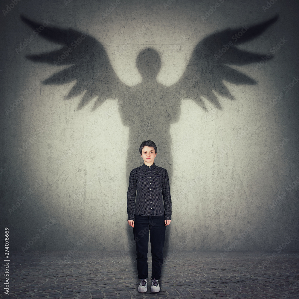 Casual confident woman full length portrait casting a superhero shadow ...