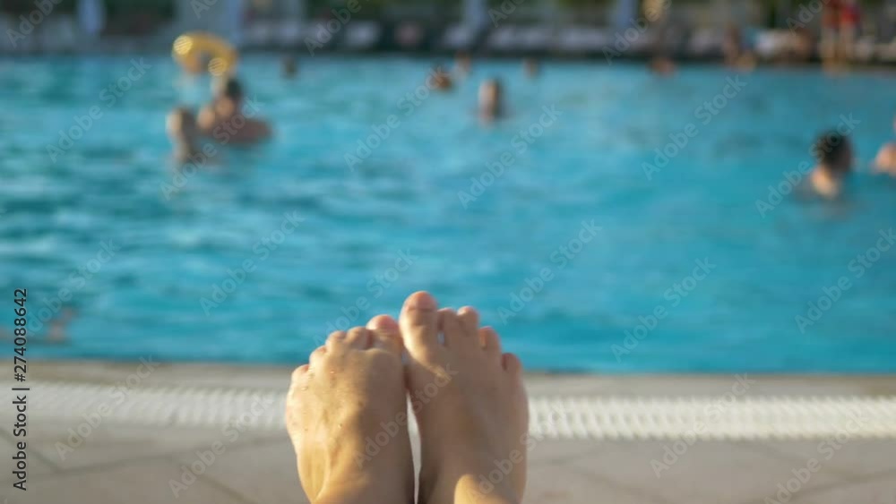 Vidéo Stock Girl relaxing at swim pool in aqua park. Woman legs at ...
