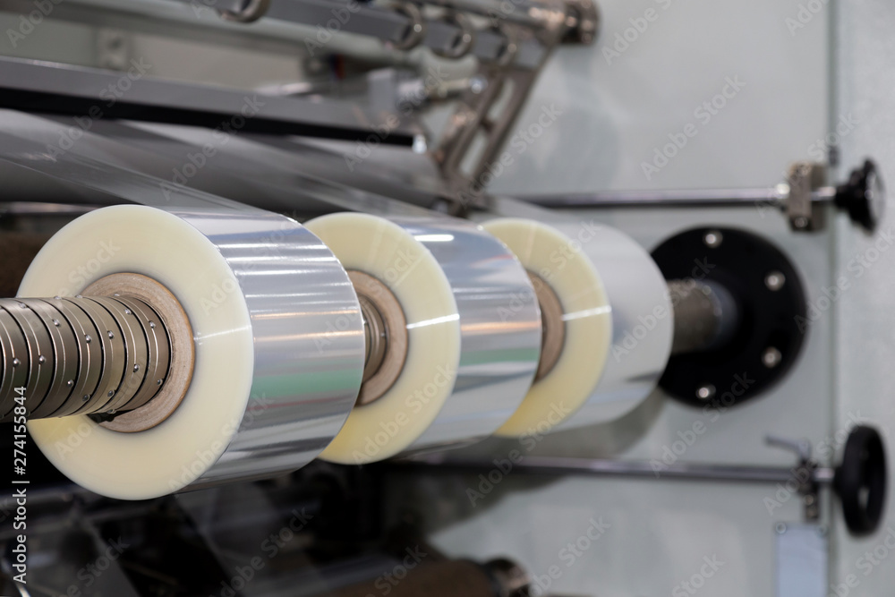 roll of plastic packaging film on the automatic packing machine in food ...