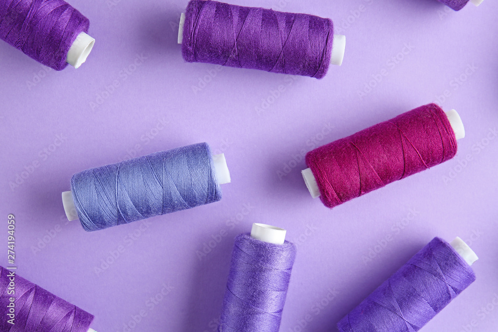 Many sewing threads on color background Stock Photo | Adobe Stock