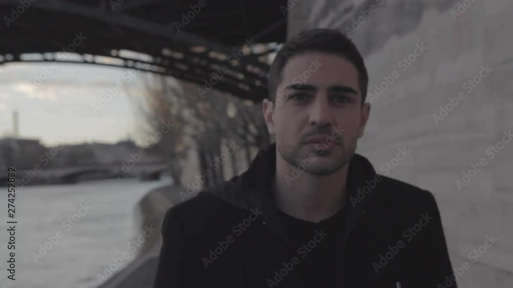 Video Stock Handsome young depressed man walking on the banks of the ...