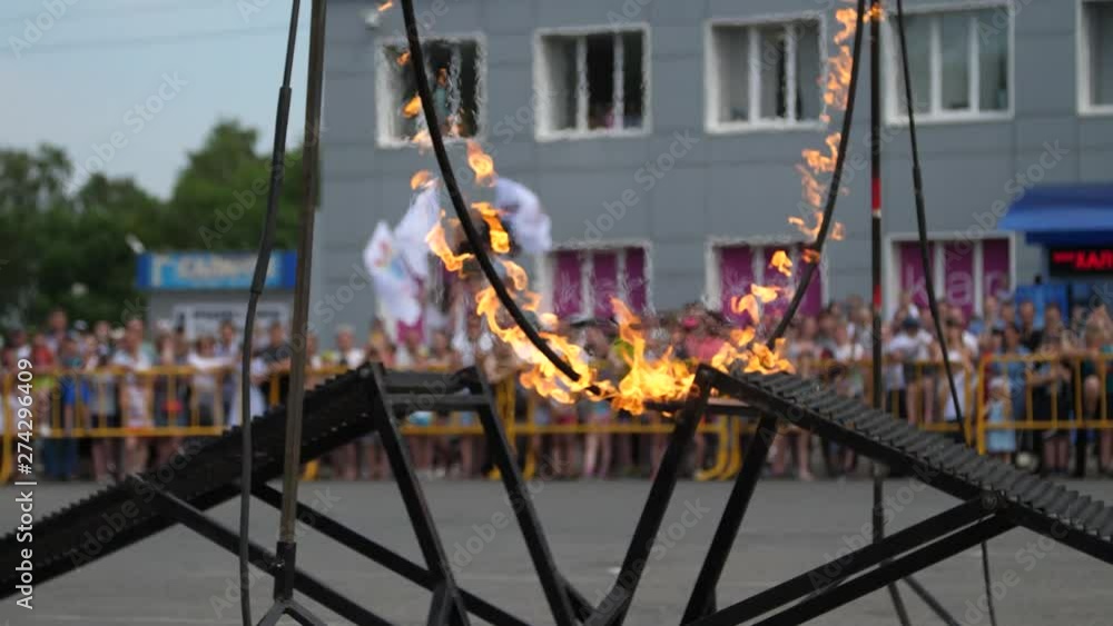 motorcyclists jump through the ring of fire on a motorcycle show ...