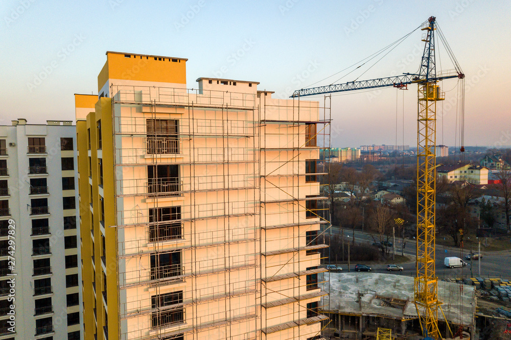 Apartment or office tall unfinished building under construction. Brick ...
