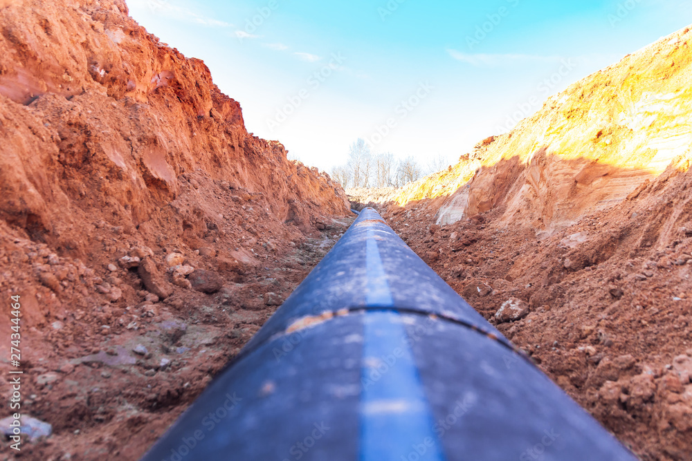Plastic water pipe lay in a trench Stock Photo | Adobe Stock