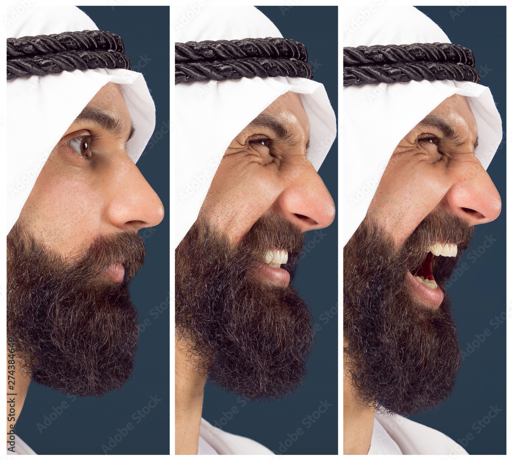 Half-length portrait of arabian saudi businessman on dark blue studio ...