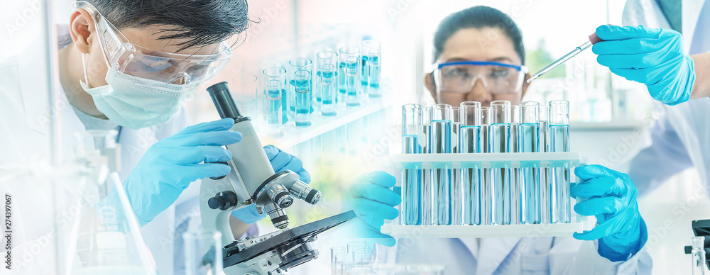 Team scientist working in laboratory. Test tubes with liquid in ...