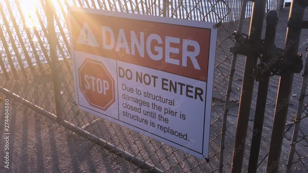 Pier closed signs of danger where a beach is not safe and falling into ...