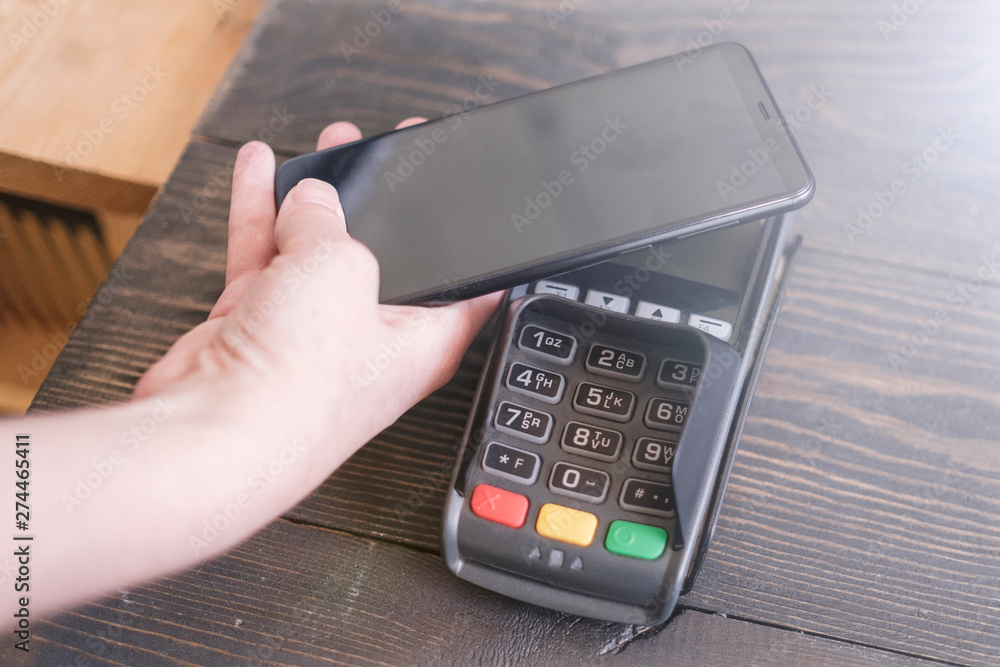 POS terminal, Payment Machine with mobile phone on store background ...