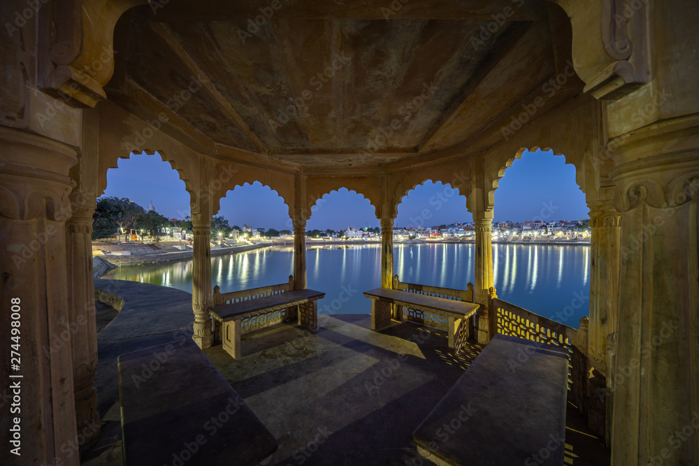 Pushkar lake after sunset, seen through Indian window frame. Pushkar ...