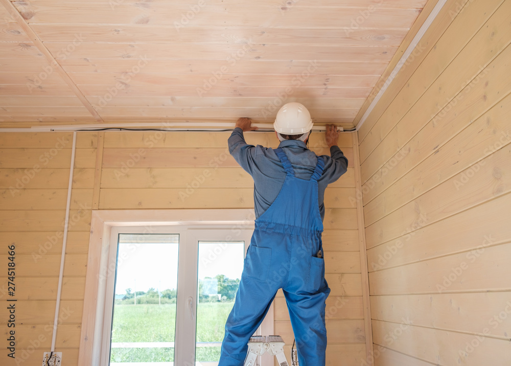 electrical engineer performs installation of electrical wiring in a new ...