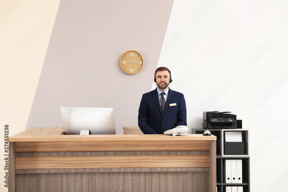 Portrait of receptionist working at desk in modern hotel Stock-Foto ...