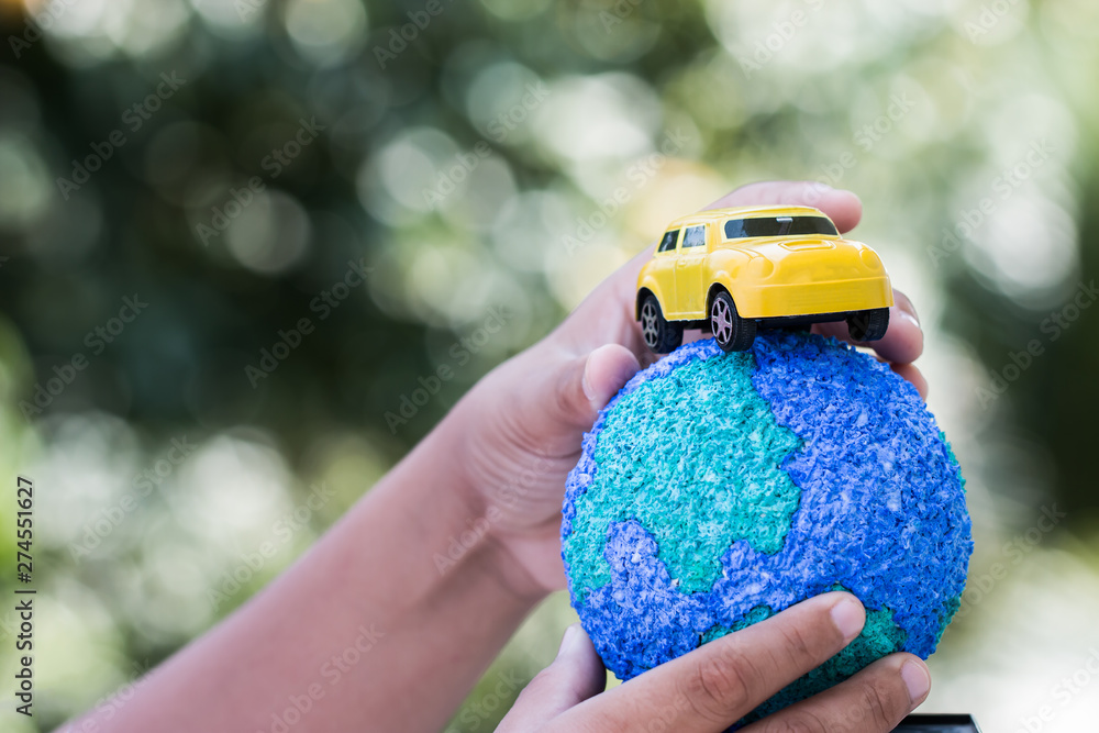 Eco friendly Save world concept. Yellow car and Hands holding Model ...