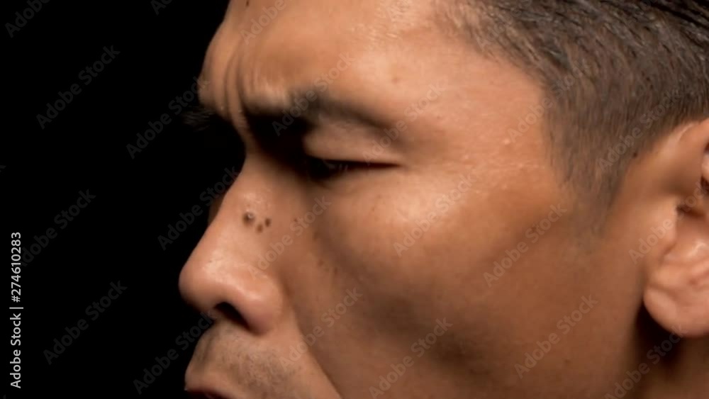 This video shows the profile of an asian man as he is coughing and ...
