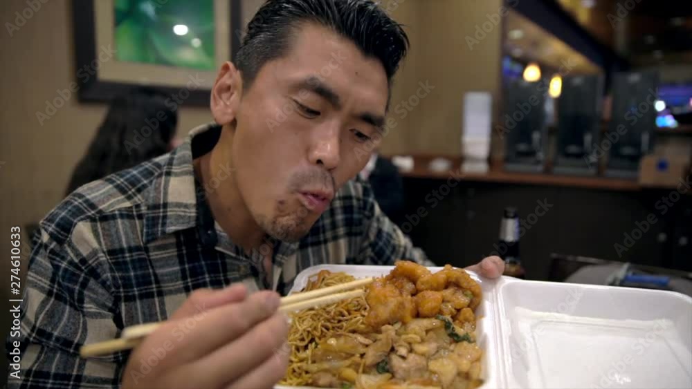 This video shows a hungry young tattooed asian man eating and devouring ...