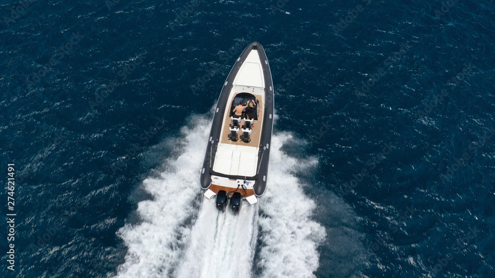 Aerial photo of inflatable rib speed boat cruising in high speed deep ...
