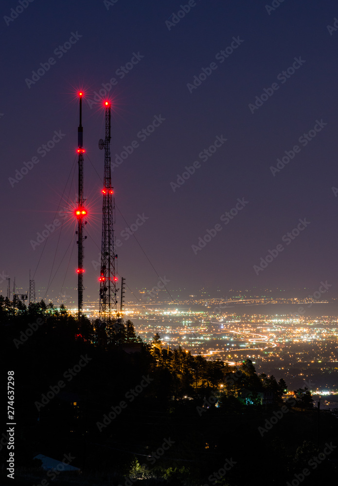 Antenna Towers on a hill over a brilliantly lit city at night Stock ...