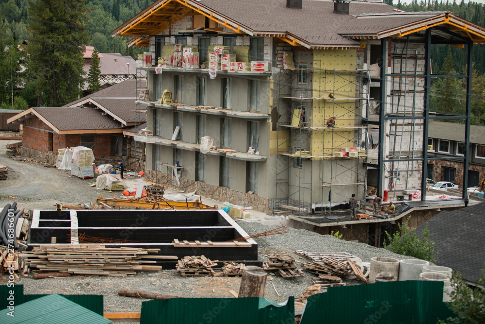 Builders producing a steel reinforcing bar on a construction site ...