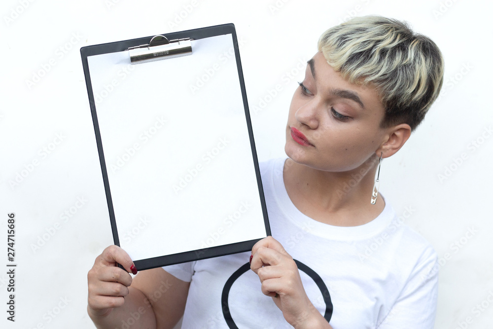Young blonde girl showing blank white big A4 paper. Leaflet ...