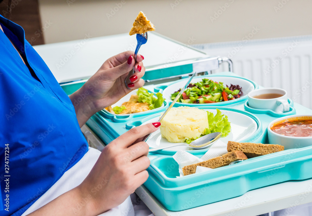 Tray with breakfast for the young female patient. The young woman ...
