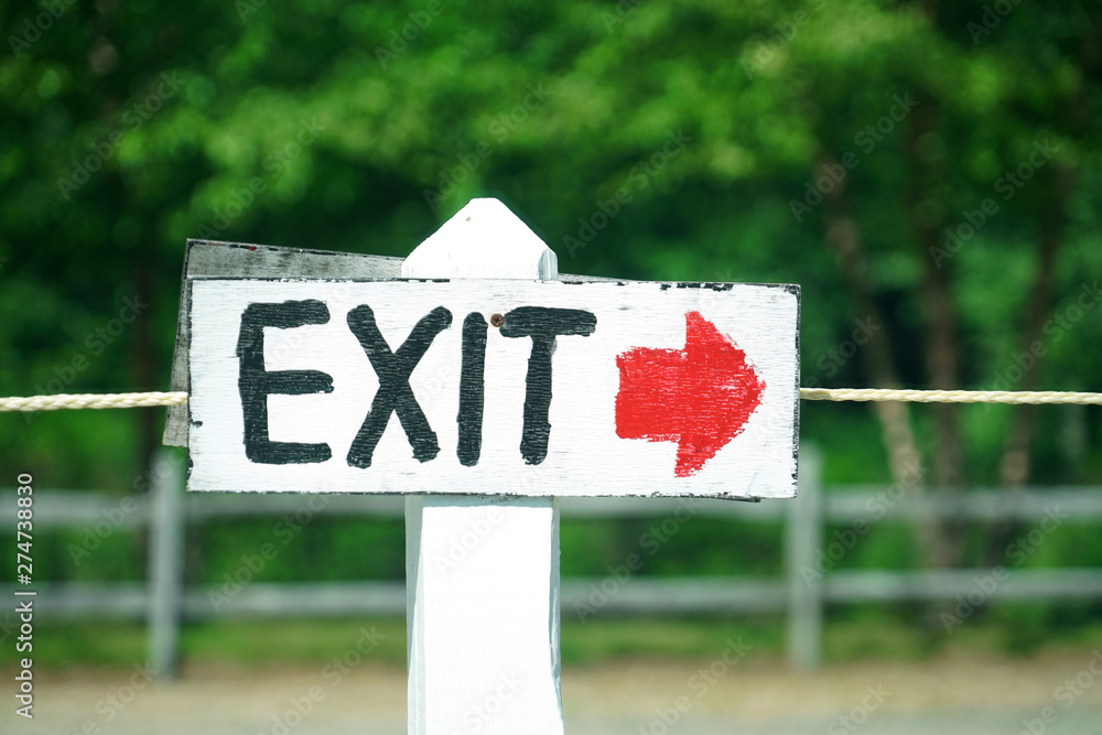 exit and arrow sign outdoor in front of trees Stock Photo | Adobe Stock