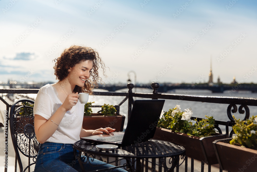 Cute happy young girl working on computer and smiling. Beautiful woman ...
