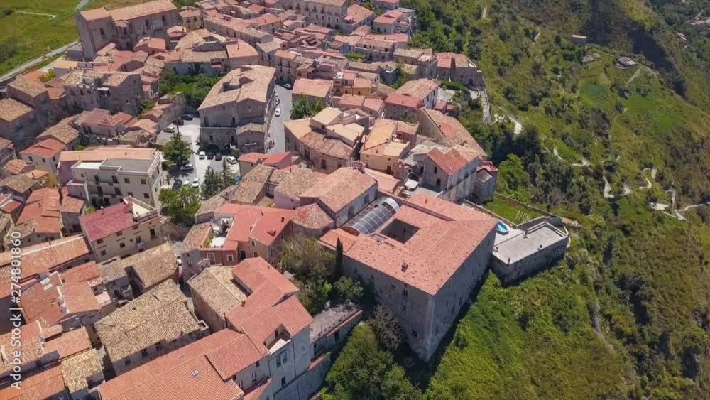 Aerial view of ancient village on hill overlooking mountain gorge ...