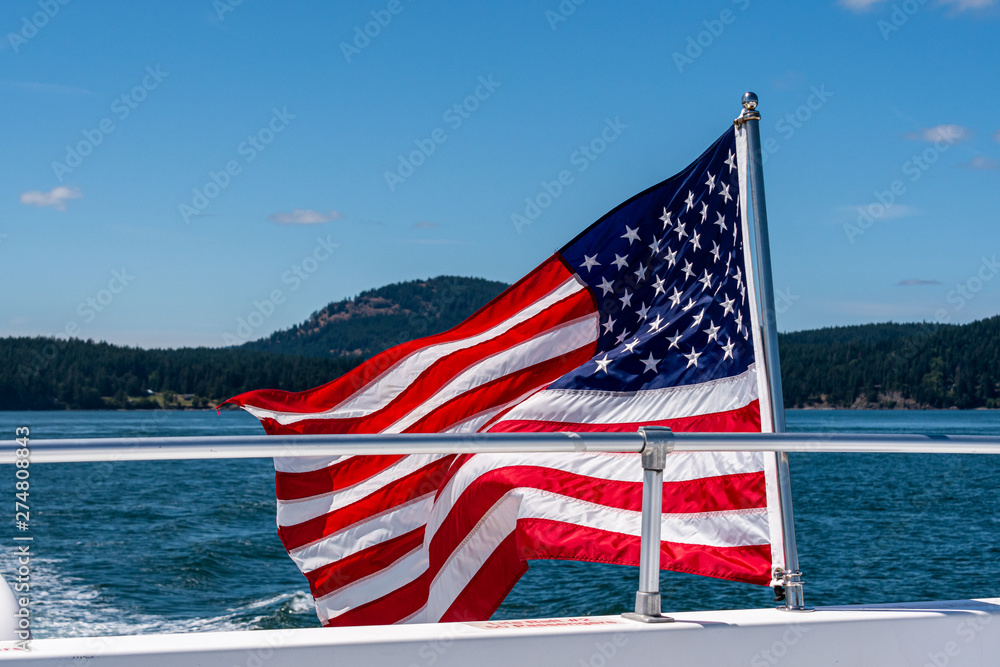 Symbol of freedom, American flag flying on the back of a boat cruising ...