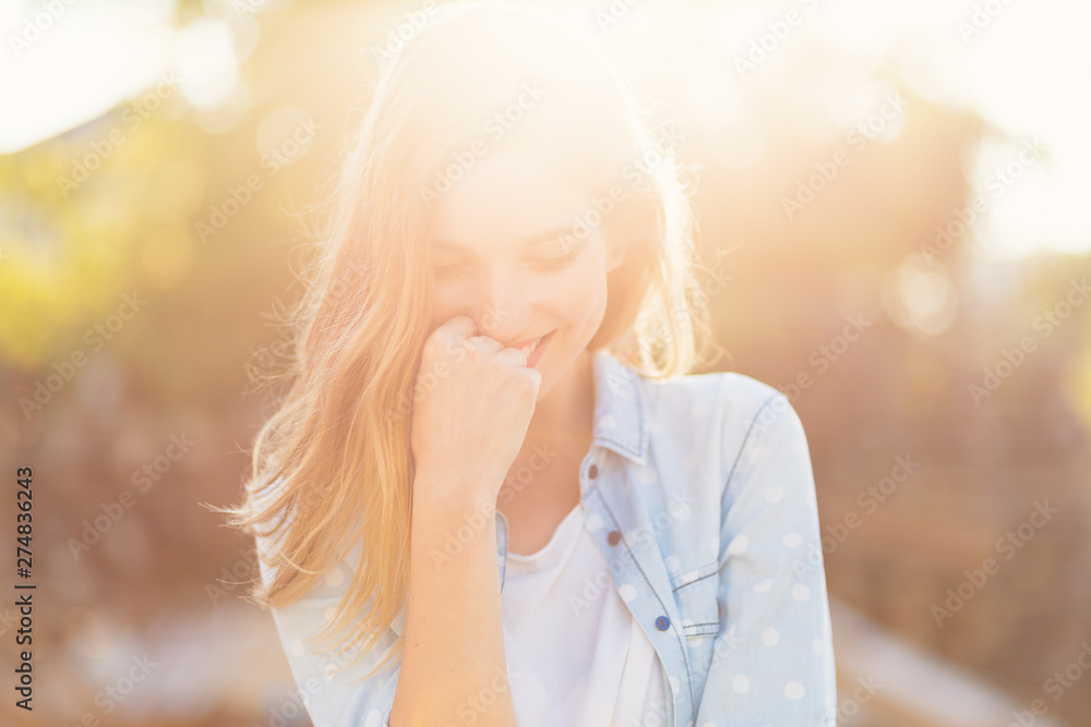 Gorgeous girl with a beautiful smile and sunrays reflected on her happy ...