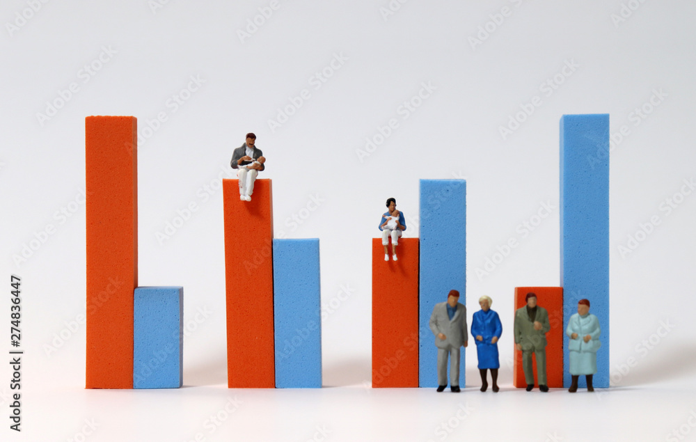 Miniature people standing in front of a bar graph and Miniature people ...