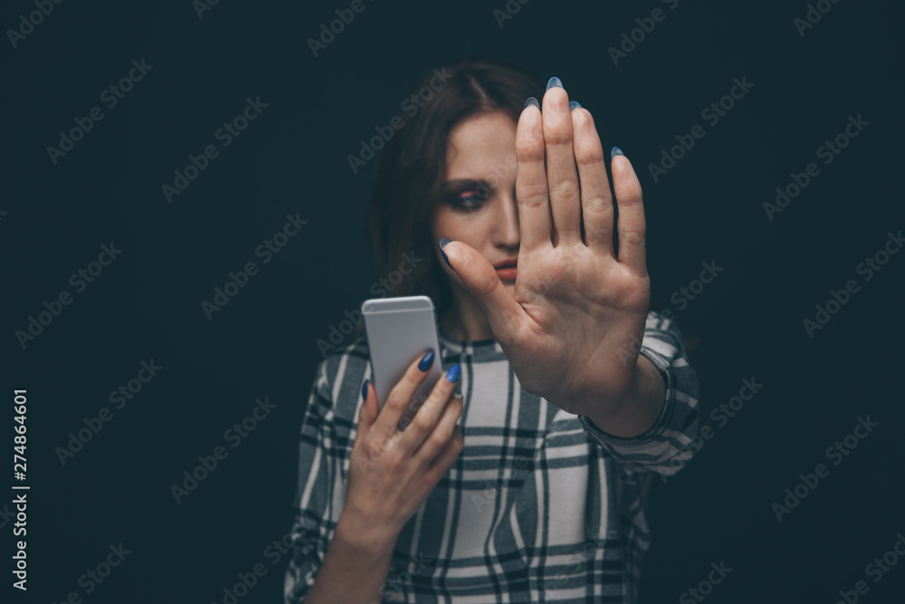 Sad teen being victim of cyber bullying online sitting on a couch in ...