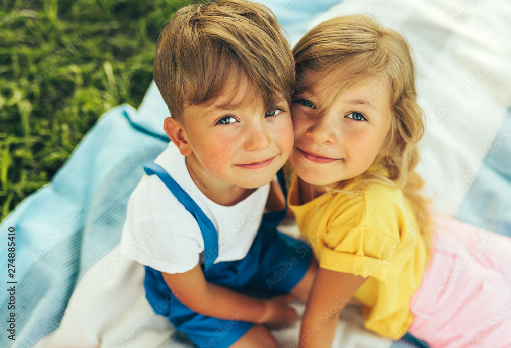 Outdoors close up portrait of smiling two children playing on the ...