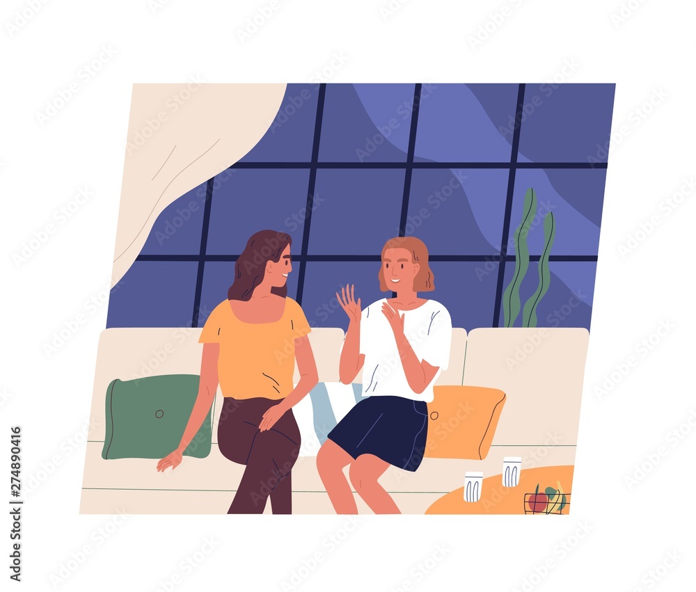 Pair of happy young girls sitting on couch and talking. Two female ...