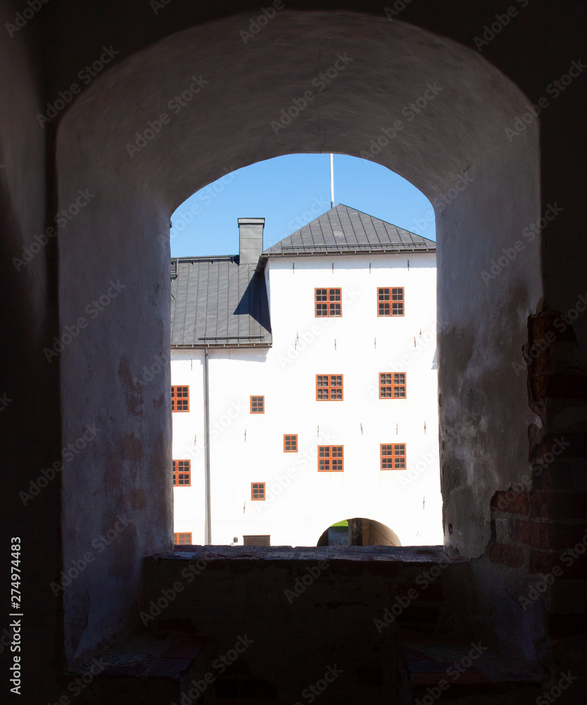 An arched window opens onto the inner, authentic courtyard of the ...