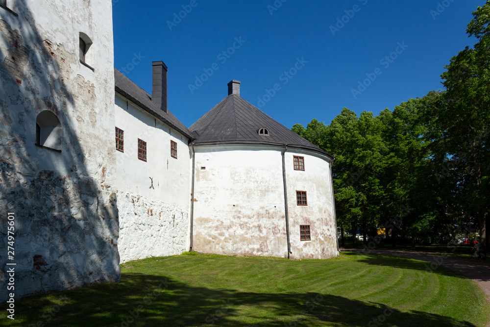 Round brick tower and wall of the historic medieval Swedish castle-fort ...