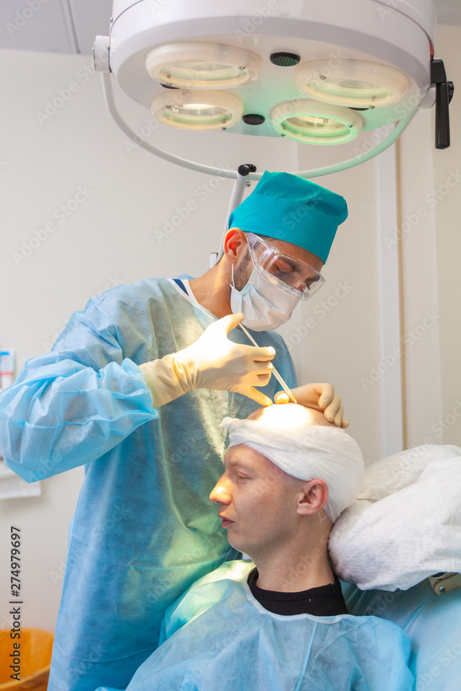 The surgeon gives injections to the head. Baldness treatment. Hair ...