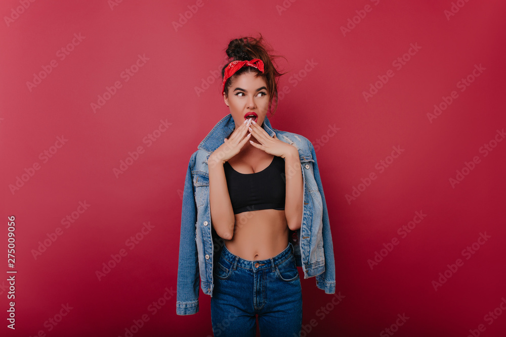 Surprised stunning lady in jeans looking away. Ecstatic female model in ...