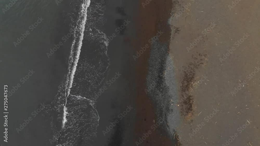 contrasting aerial of hilo bay's massive black sand beach ...