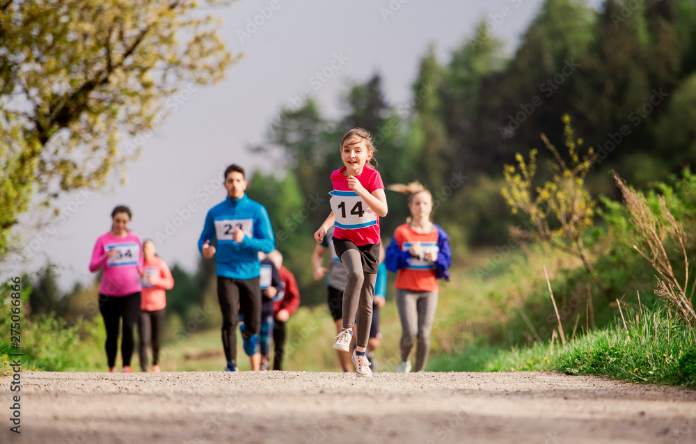 Large group of multi generation people running a race competition in ...