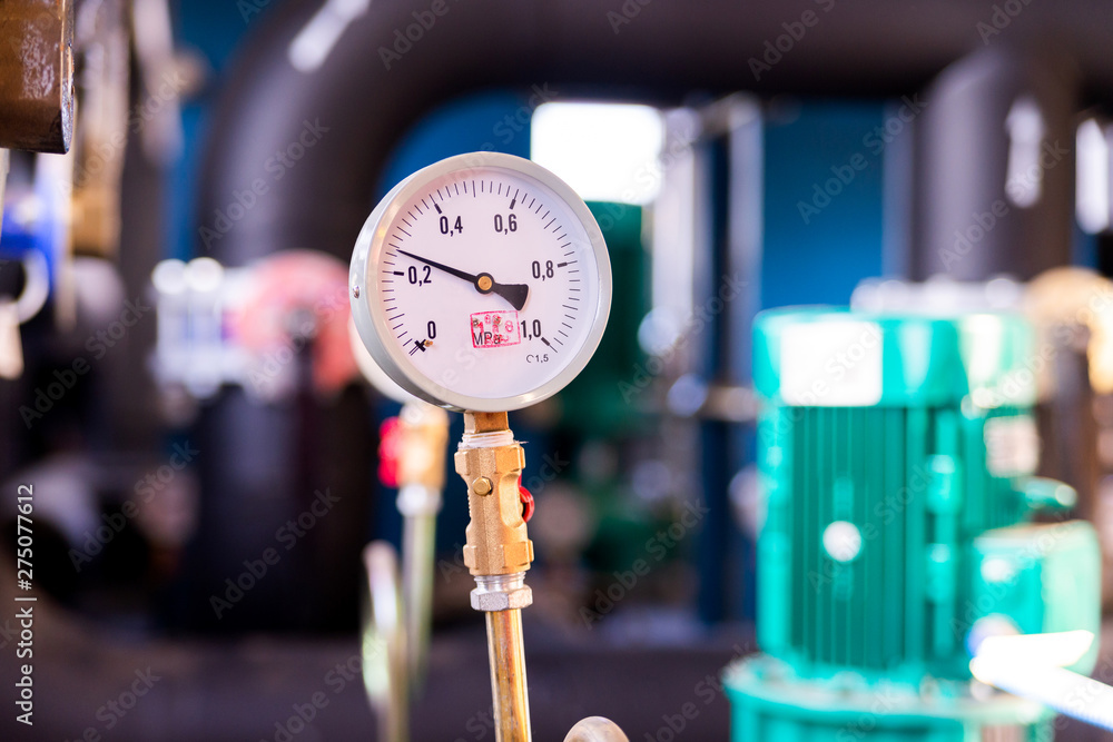 Closeup of manometer, measuring gas pressure. Pipes and valves at ...