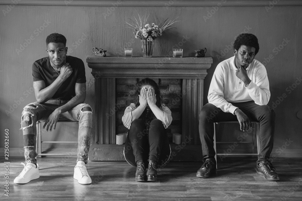 Kidnapped woman concept. Despair young girl sitting on floor betwen two ...