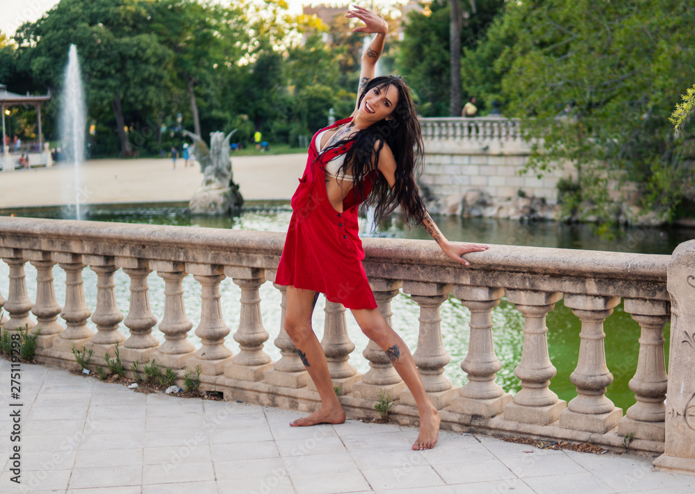tattooed transgender model is dancing in the green park. Emotional ...