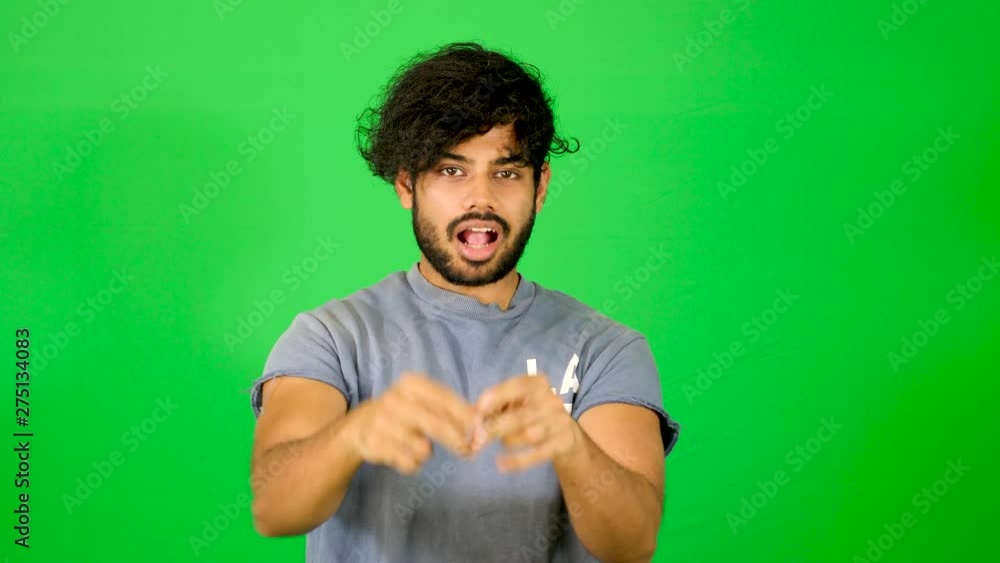Indian guy showing up and saying hello to the camera with waving hand ...