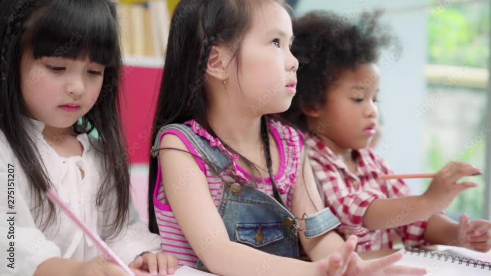 Slow motion - Group of children drawing in classroom, Multi-ethnic ...