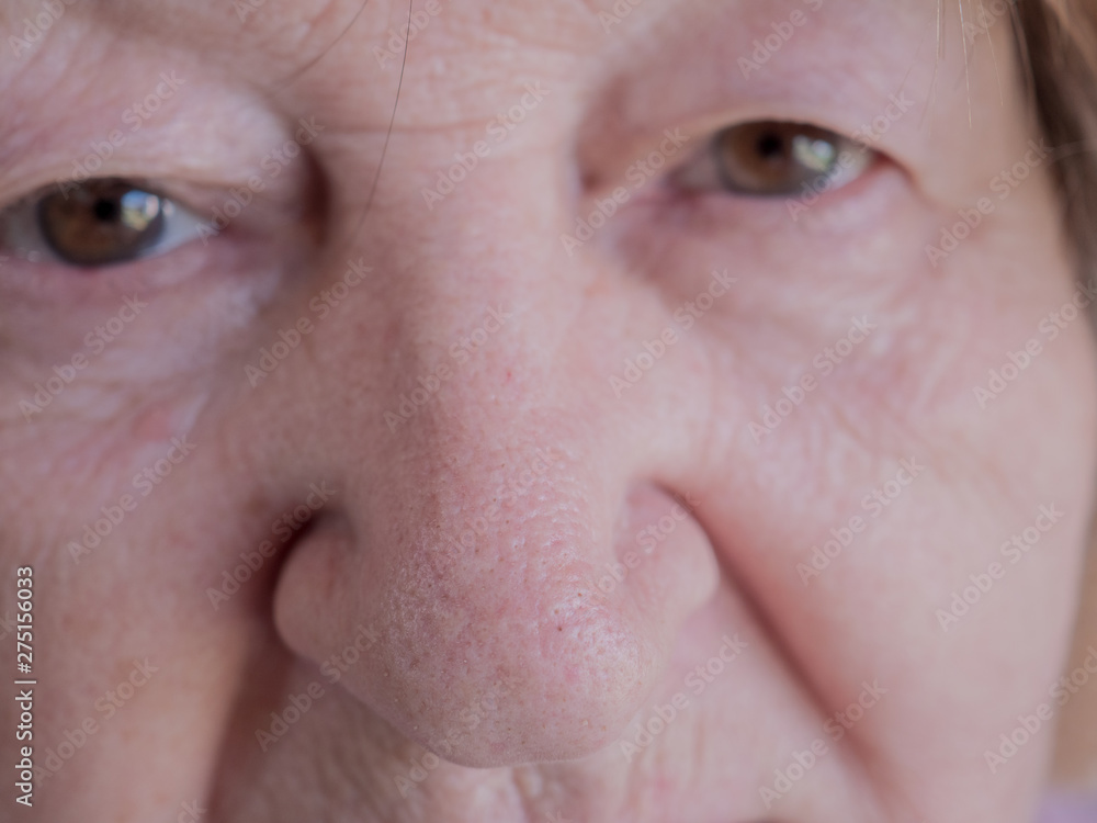 Elderly woman 70 years. Face close up. Eyes, eyebrows, lips, nose ...