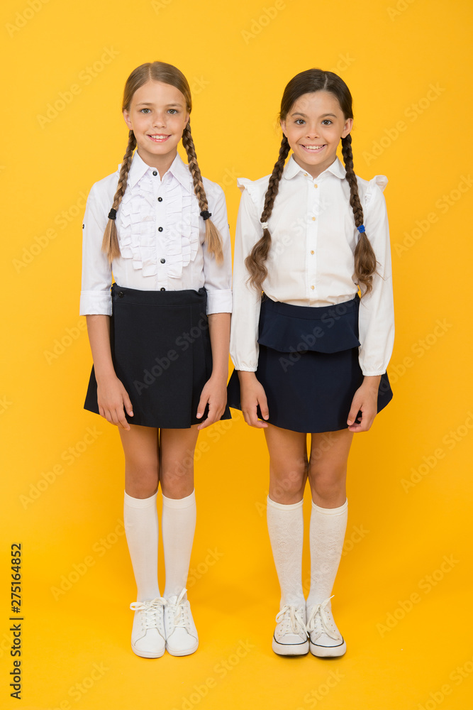 Making everything right. Excellent pupils. Girls perfect uniform outfit ...