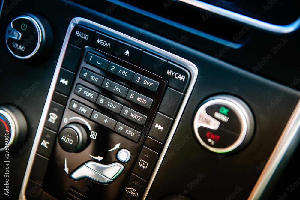Side view of modern luxury car dashboard with control of the phone ...